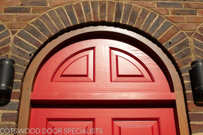 Five panel front door and arched frame